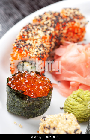Sushi roll set with shrimp, flying fish reo, avocado and cucumber on a ...