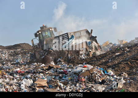 Tractor compactor/dozer 'track laying' pushing trash at landfill ...