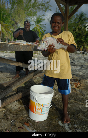 Young boy cleaning fish at Crooked Island Bahamas Stock Photo - Alamy