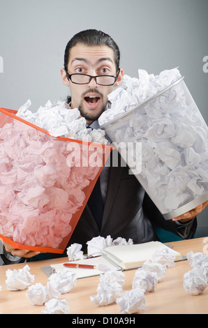 Man with lots of wasted paper Stock Photo - Alamy