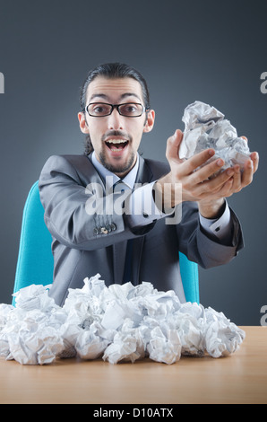 Businessman with lot of discarded paper Stock Photo - Alamy