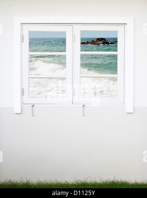 Detail of a modern wooden house by the sea with front door and windows ...