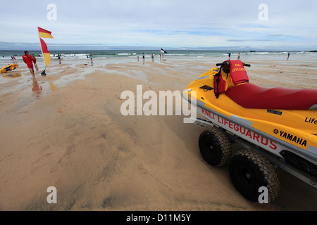 Cornwall, England. An RNLI lifeguard's quad bike and jet ski PWC rescue ...