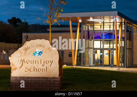 Carved school name on stone at the main entrance to Mountjoy School in ...