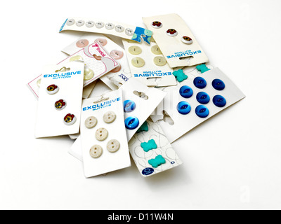 A Pile Of Buttons On Cardboard Stock Photo - Alamy