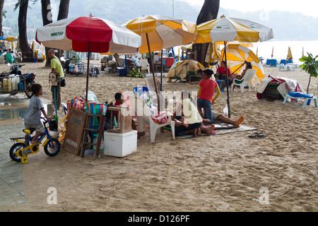 Tourists enjoying a traditional Thai Massage on the Beach of Patong on Phuket Island, Thailand ...
