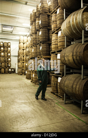 A worker counts whisky casks in the warehouse at the Warengham ...
