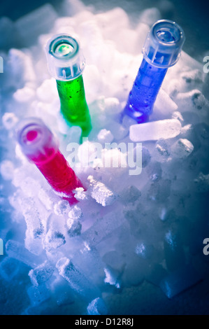 Three glass test tubes in stand, two containing oil and water, and one ...