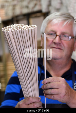Wound wooden sticks and handles for batons are produced at the baton ...
