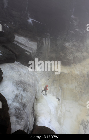 People walking at the frozen Kinder Downfall, High Peak in Derbyshire ...