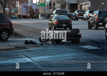 Wrecked motorcycle on road, traffic accident, casualty being taken to ...