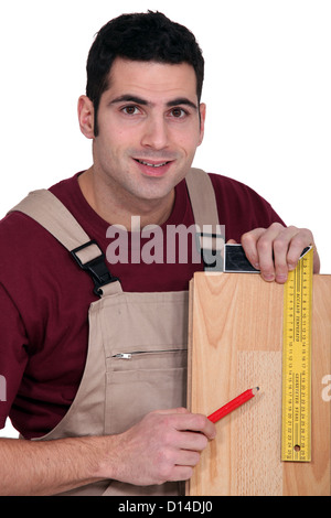 Tradesman using a try square to measure an angle Stock Photo - Alamy