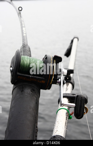 fishing rod and spinning reel and sea water background Stock Photo - Alamy