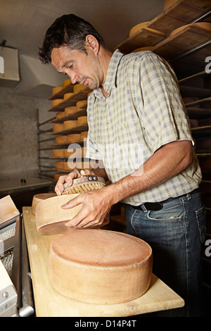 Man holding a wheel of cheese Stock Photo - Alamy