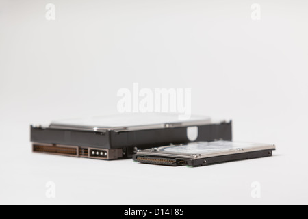 A large hard drive and a small hdd on a red background. The concept of ...