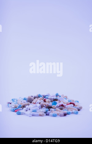 Pills, tablets, drugs, meds, medications on white surface - close up ...