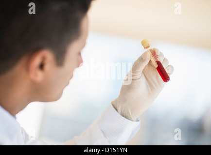 Close-up of laboratory technician holding blood sample for medical ...