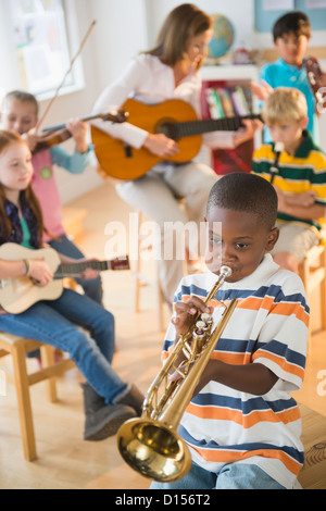 School children playing musical instruments in band Stock Photo - Alamy