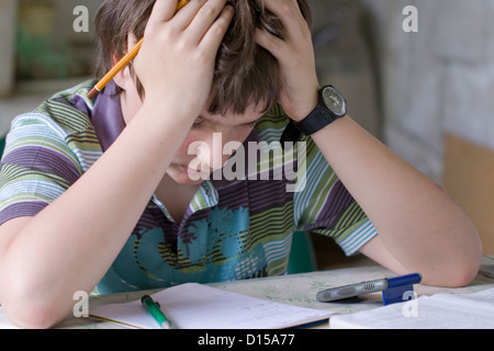 A boy hardly solving homework Stock Photo - Alamy