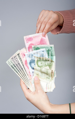 Hand holding American dollar banknotes isolated on wooden background ...
