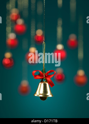 Golden christmas bell on a blue background Stock Photo - Alamy