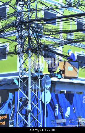 A confusion of power lines in an urban back alley Stock Photo - Alamy
