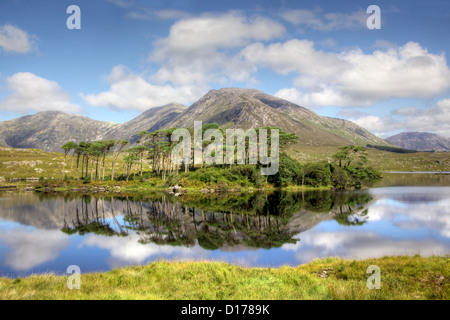 A mountainous landscape reflected in Derryclare Lough, in the Inagh ...