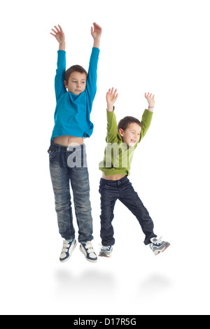 Two little boys jumping on trampoline in sport center. Kids having fun ...