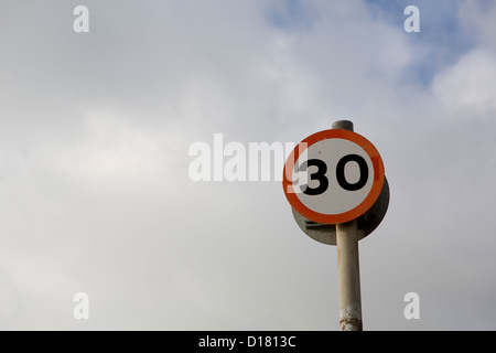 30 30mph miles per hour road sign with lights at the side of the road ...