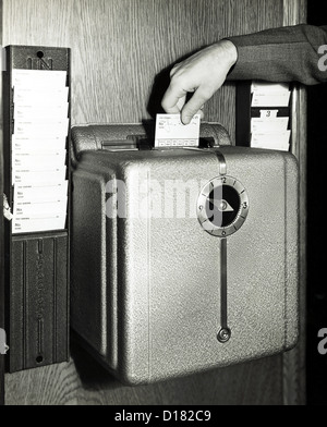 Hand putting card in time clock cut out on white background Stock Photo ...