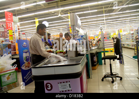working cashier in Carrefour supermarket, wearing face mask to avoid ...
