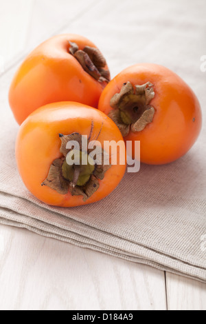 Delicious fresh persimmon fruits ready for eat on wooden background ...