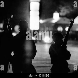 National Guard troops stand guard over paint peeling off the bottom of ...