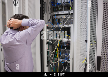 Technician feeling frustrated over servers Stock Photo - Alamy