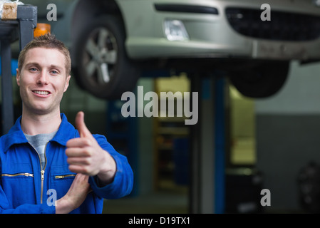 Auto mechanic gesturing thumbs up Stock Photo - Alamy