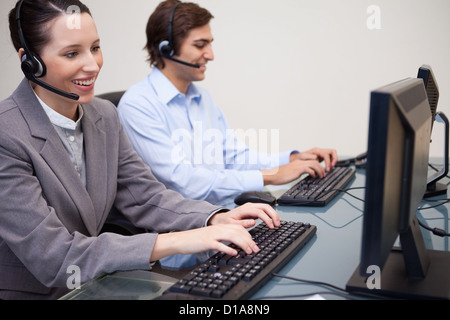 employees talking to a customer sitting at the Desk Stock Photo - Alamy