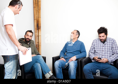 Doctor saying hello to patient in waiting room Stock Photo - Alamy
