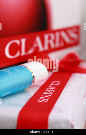 A Clarins shopping bag, wrapped Clarins gifts and loose products in ...