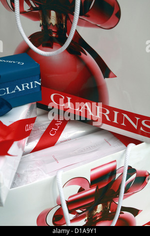A Clarins shopping bag, wrapped Clarins gifts and loose products in ...