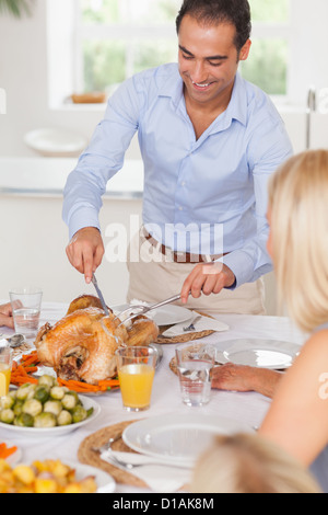 Man standing to carve the turkey Stock Photo - Alamy
