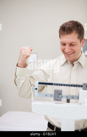 happy man celebrating victory over gray background Stock Photo - Alamy