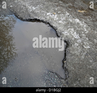 Potholes pot holes in a country lane road Stock Photo - Alamy