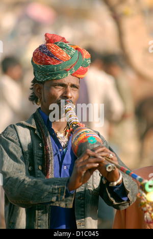 Indian snake charmer plays flute-like gourd instrument called a pungi ...