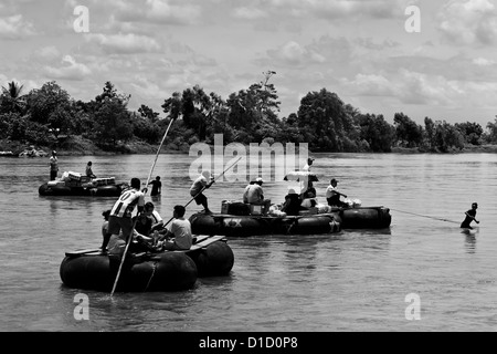 A makeshift inner tube raft, carrying immigrants from Central America ...