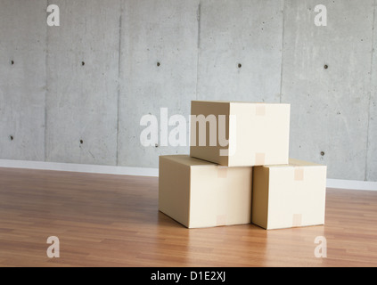Concrete wall and cardboard boxes Stock Photo - Alamy