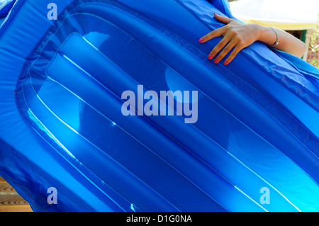 Stock photo of a girl blowing up an inflatable boat Stock Photo - Alamy