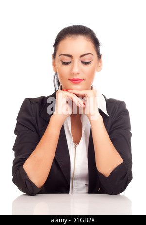 Beautiful woman posing - looking down the camera, sitting on table ...