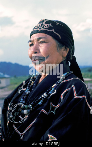 An elderly Ainu woman on the island of Hokkaido in northern Japan shows ...