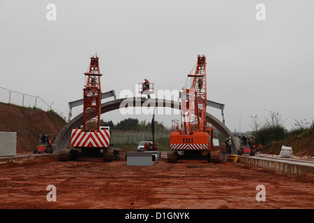 Bebo Arch bridge of precast reinforced concrete sections being lifted ...