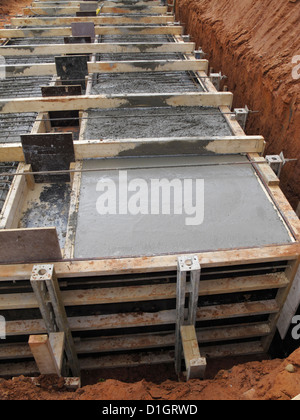 Pouring concrete for a reinforced concrete bridge foundation strip ...